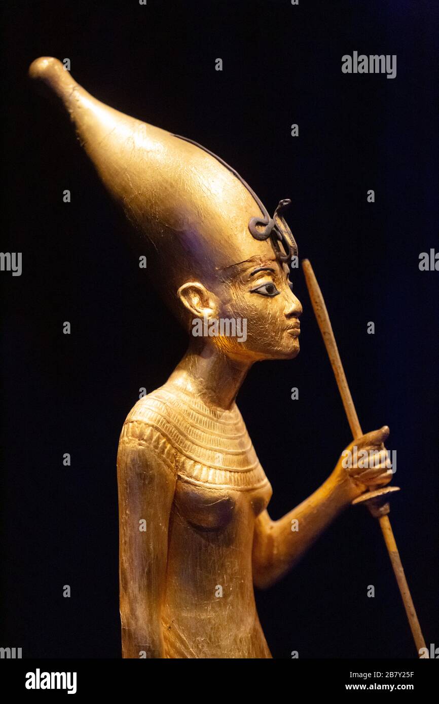 Tutankhamun statue; close up of a gilded wooden statue of the king ...