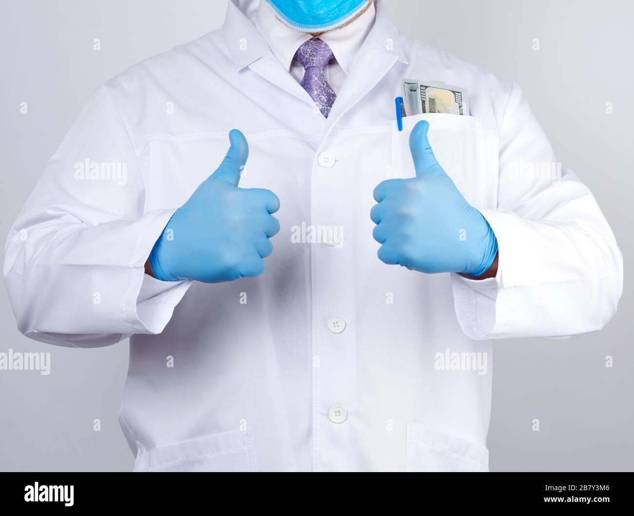 doctor in a white coat and tie shows with his hand a gesture like ...