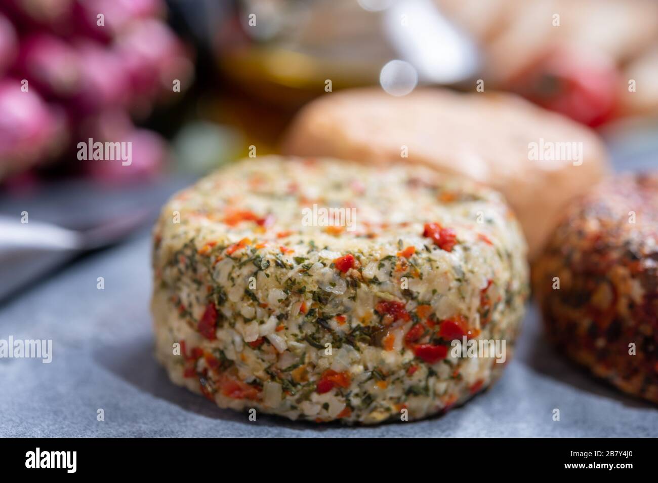 Different french soft goat cheeses made with colorful spices and herbs ...