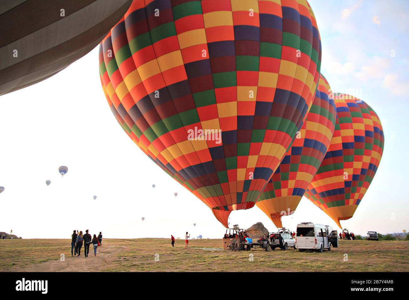 Preparing for take-off hot air balloons with tourists on sunrise Stock ...