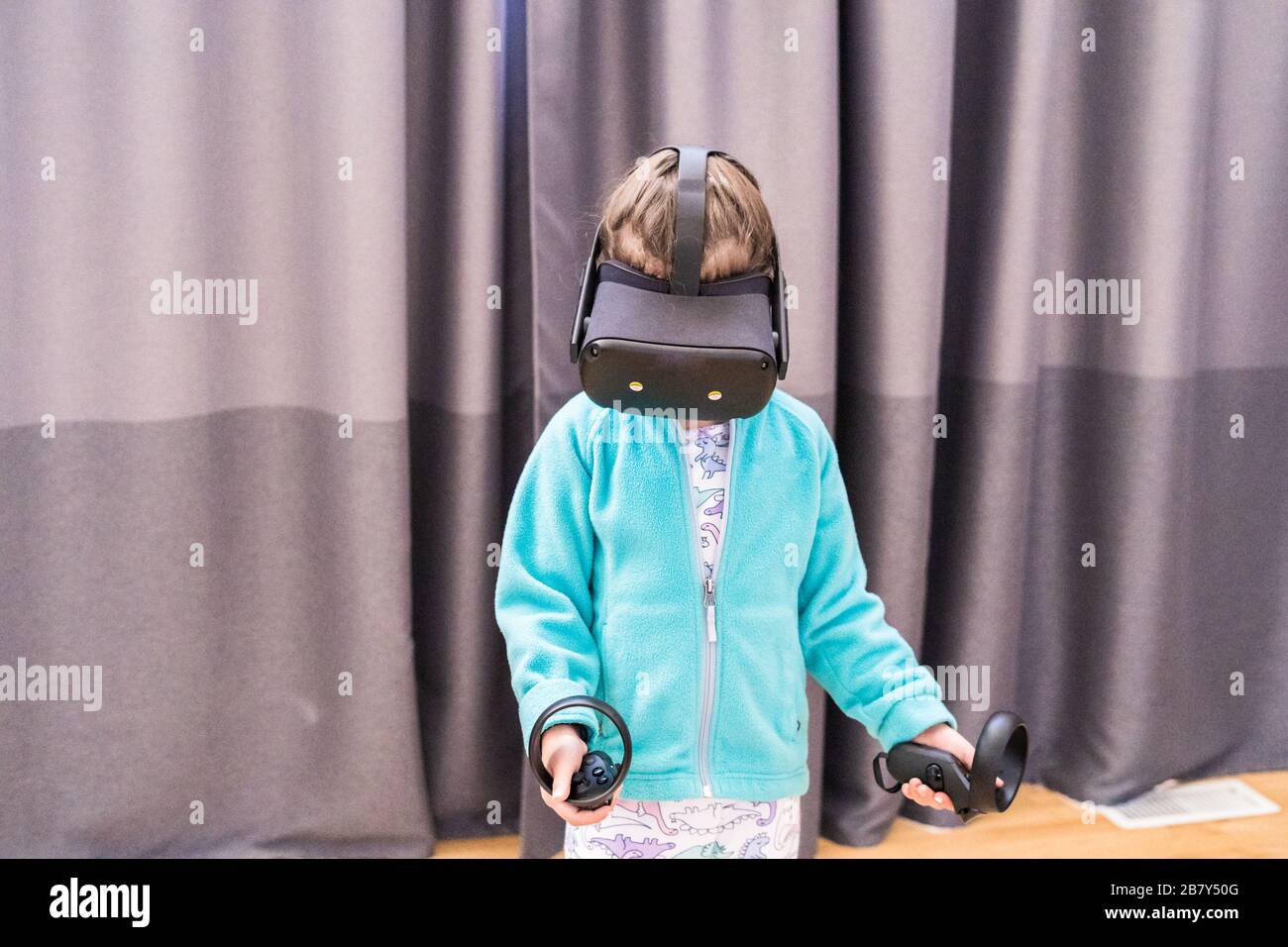 Little girl playing VR kids game in the living room Stock Photo - Alamy
