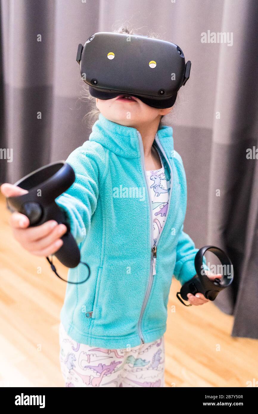 Little girl playing VR kids game in the living room Stock Photo - Alamy