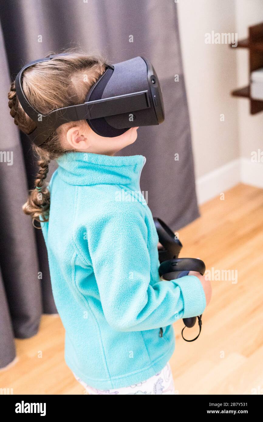 Little girl playing VR kids game in the living room Stock Photo - Alamy