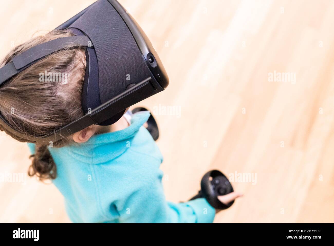 Little girl playing VR kids game in the living room Stock Photo - Alamy