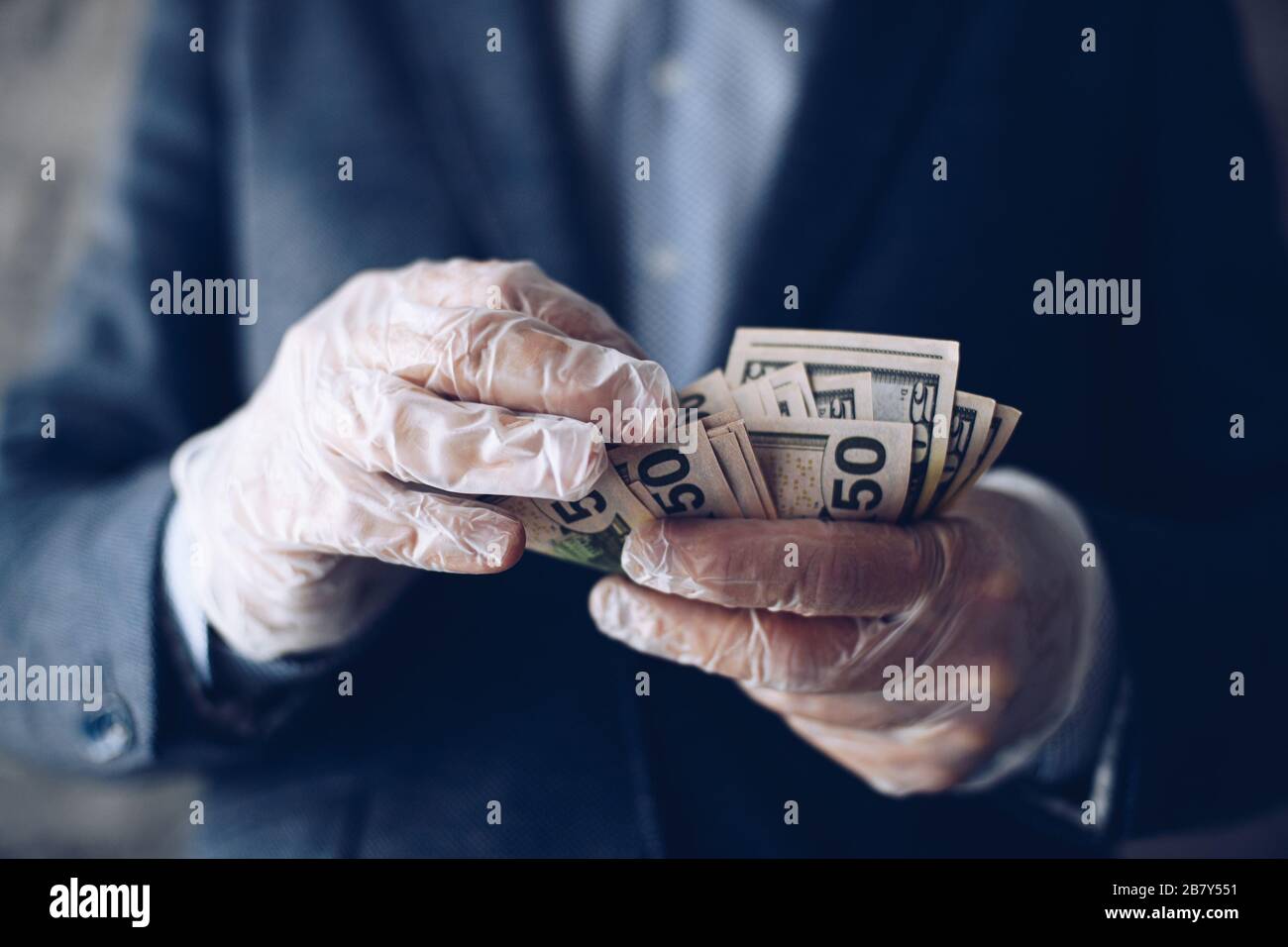 Man counting american dollars money banknotes in protective latex ...