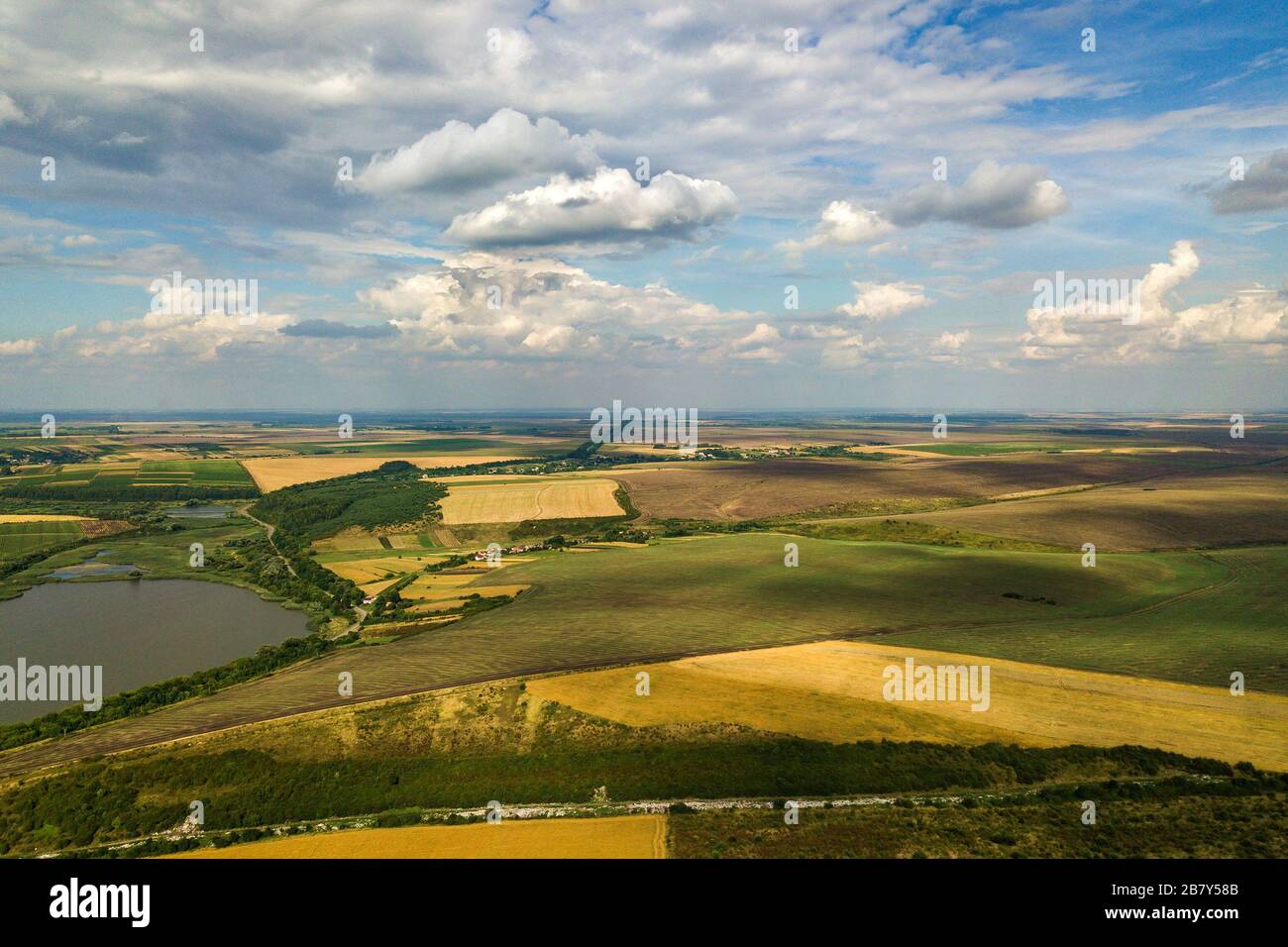 Aerial rural landscape with yellow patched agriculture fields and blue ...