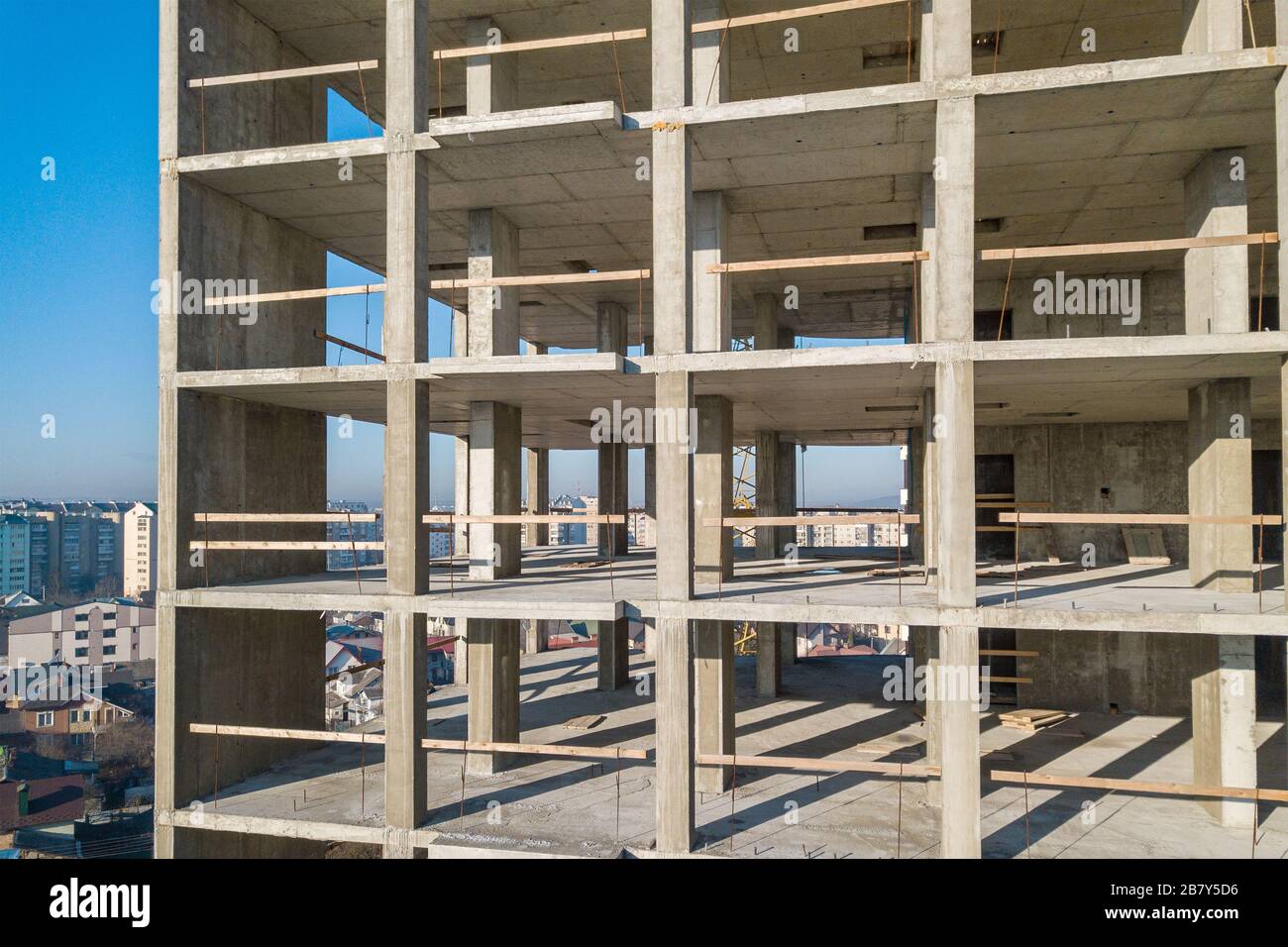 Aerial view of concrete frame of tall apartment building under ...