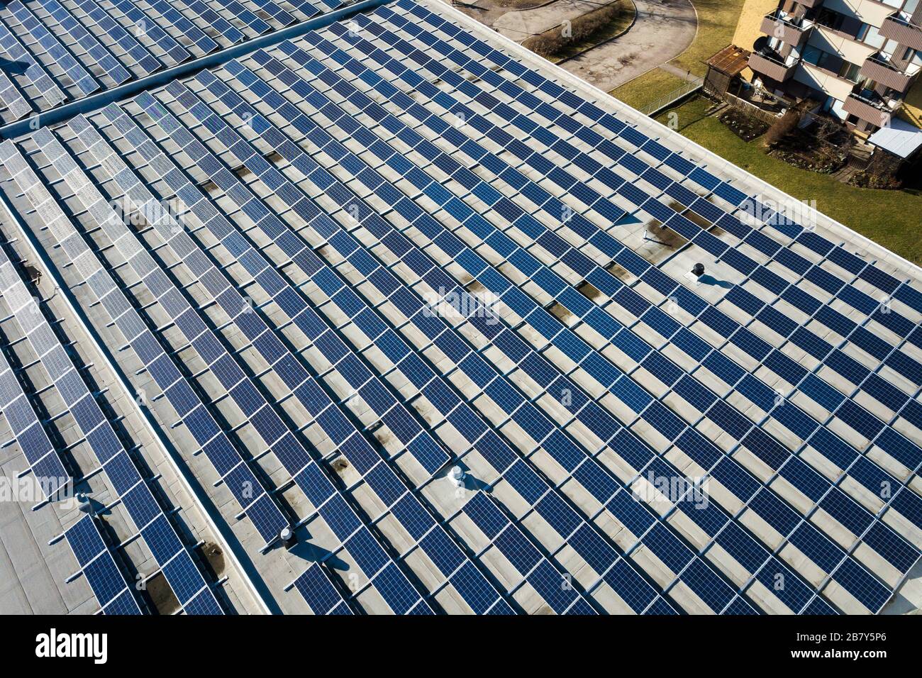 Aerial view of many photo voltaic solar panels mounted of industrial ...