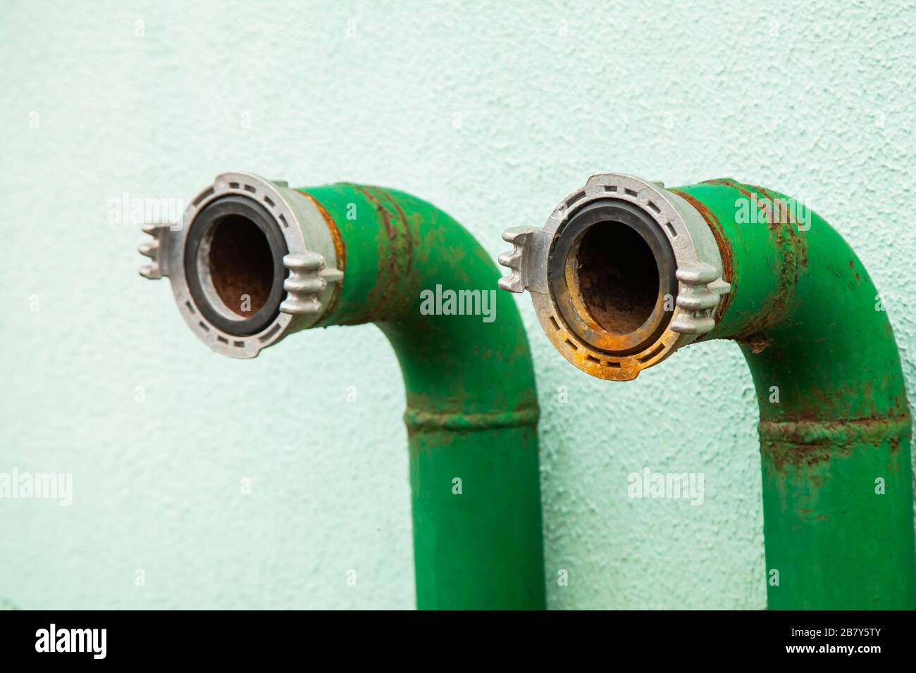 Fire hydrant nozzle green, close-up hose connection Stock Photo - Alamy