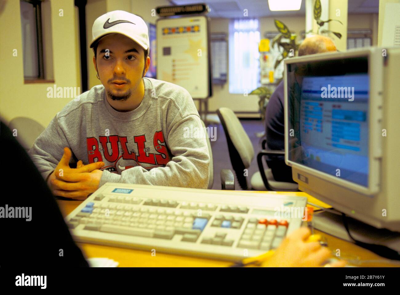 Job Centre young man out of work looking for a work being interviewed ...
