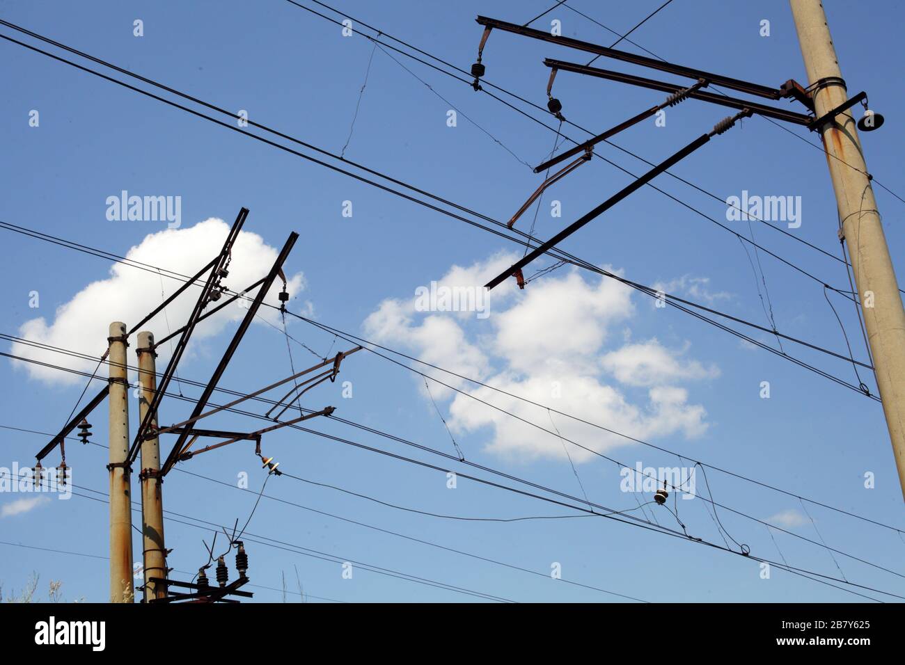 Electric wires on poles for powering an electric train Stock Photo - Alamy
