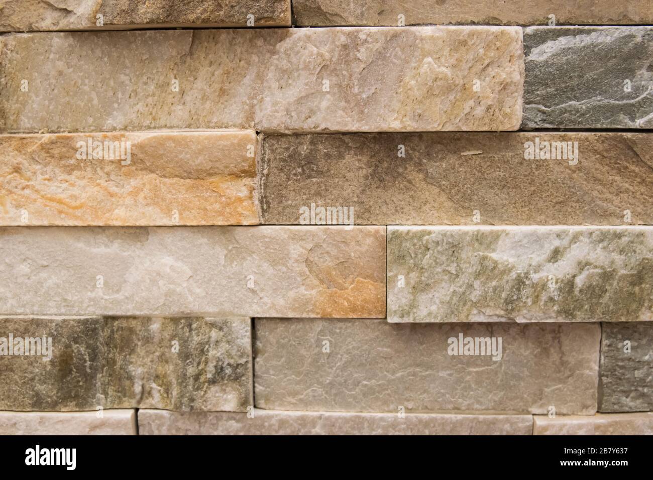 Beautiful beige structural stone wall of the ancient building consists ...