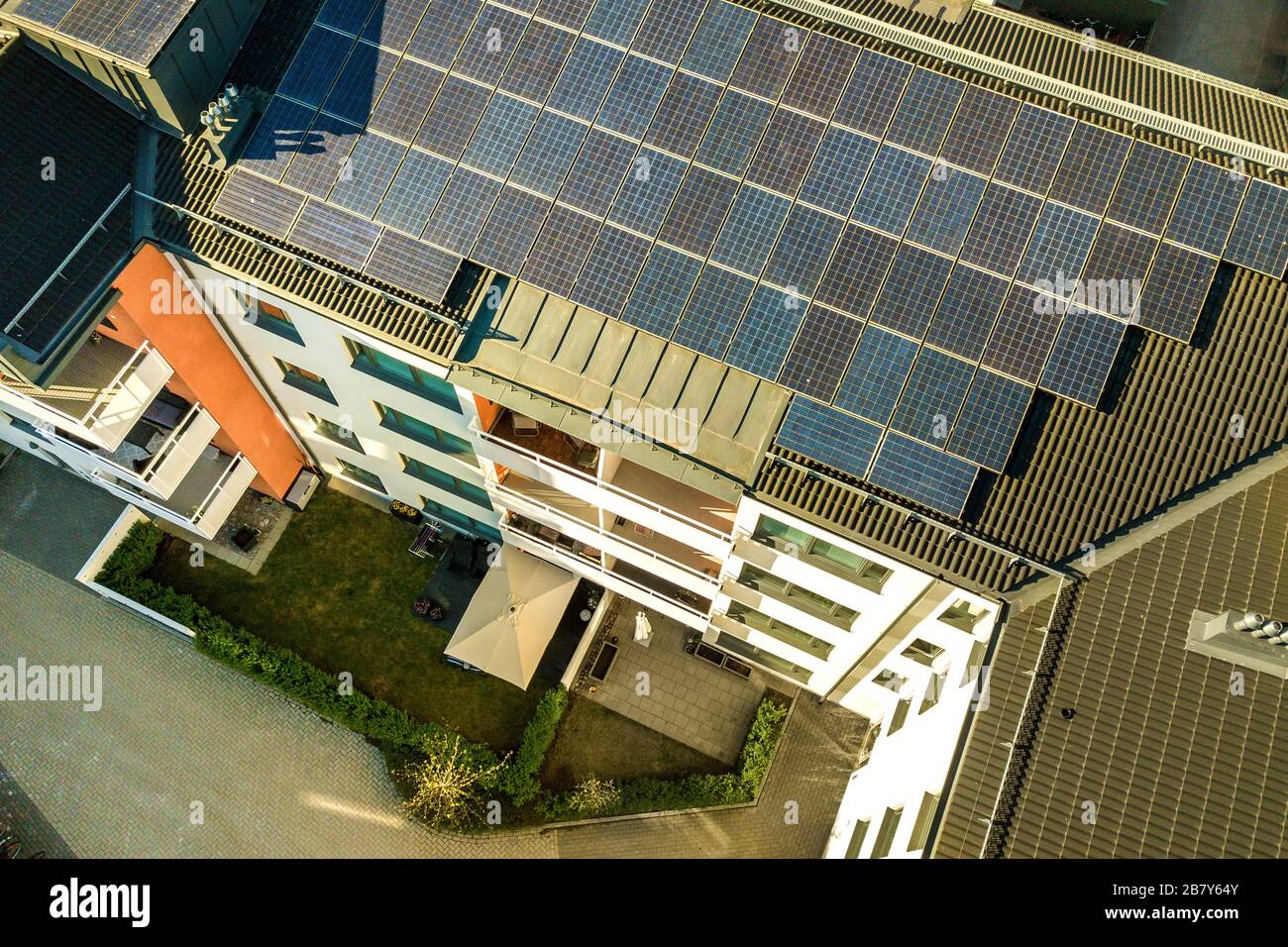 Aerial view of solar photovoltaic panels on a roof top of residential ...