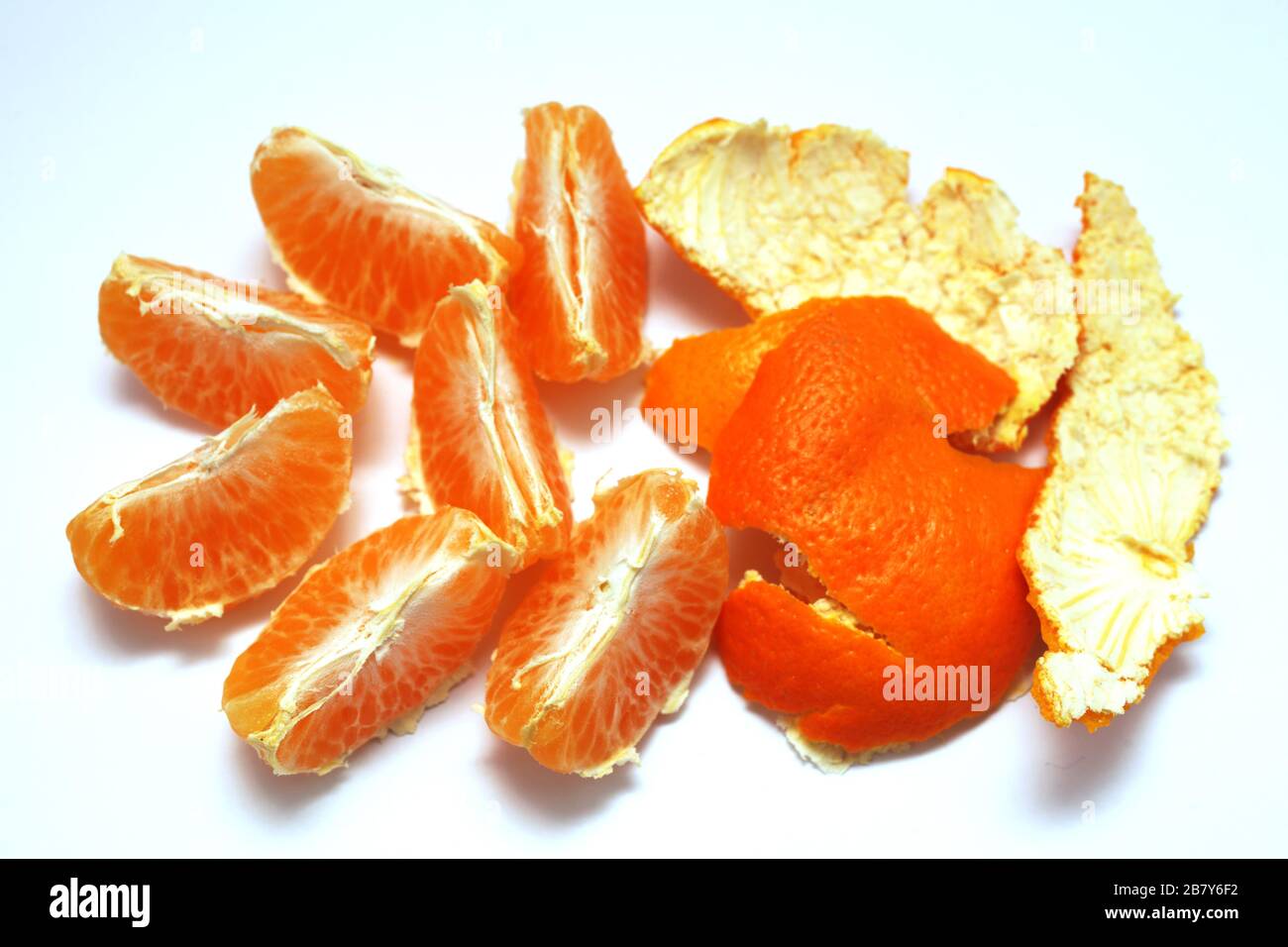 peeled mandarin divided into slices, white background close-up Stock ...