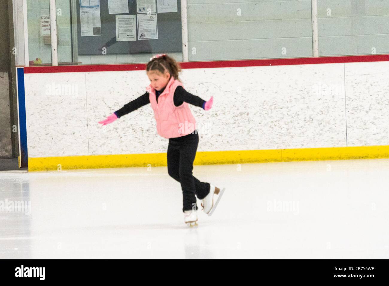 Little skater practicing her elements at the morning figure skating ...