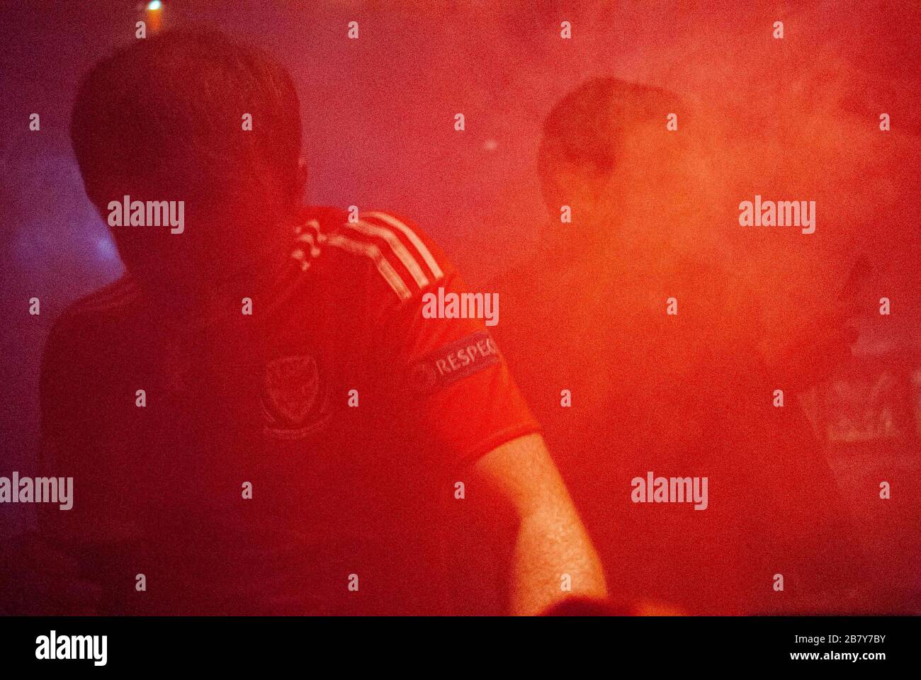 Welsh Football Fans release a red flare whilst watching the Republic of ...