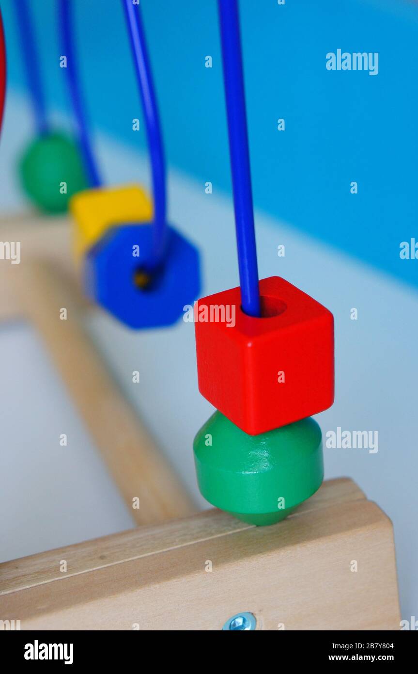 Vertical shot of a multicolored children's toy attached to a small ...