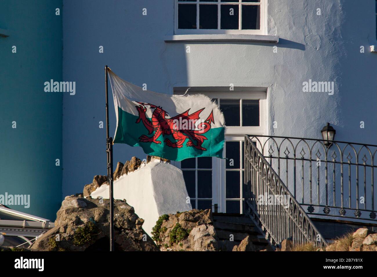 A Welsh flag flies in the wind at Tenby South Beach Stock Photo - Alamy