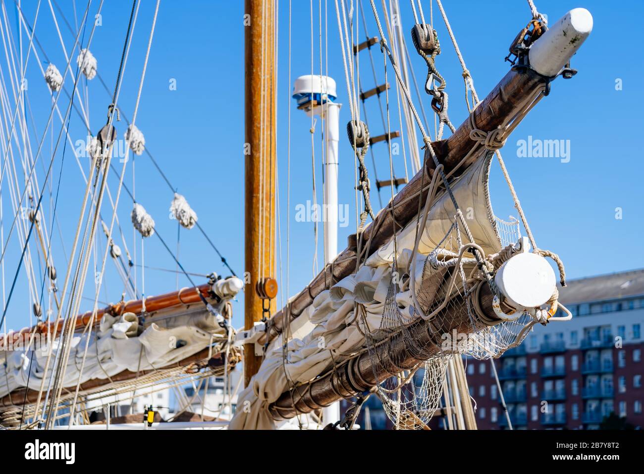 Details of the folded rigging and sail from an old sailing ship. Tall ...