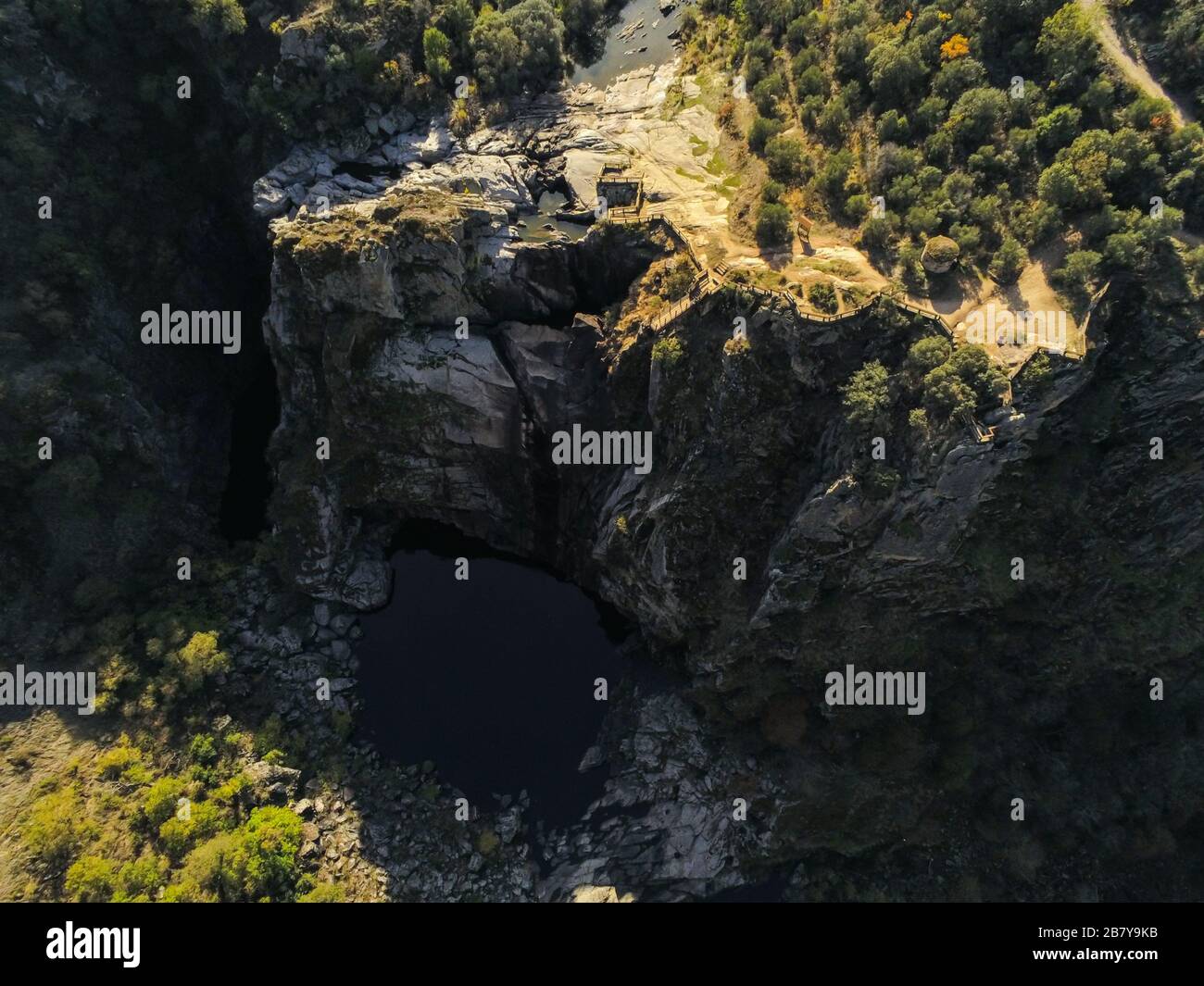 Aerial shot of a pond near a cliff at Arribes del Duero in Salamanca ...
