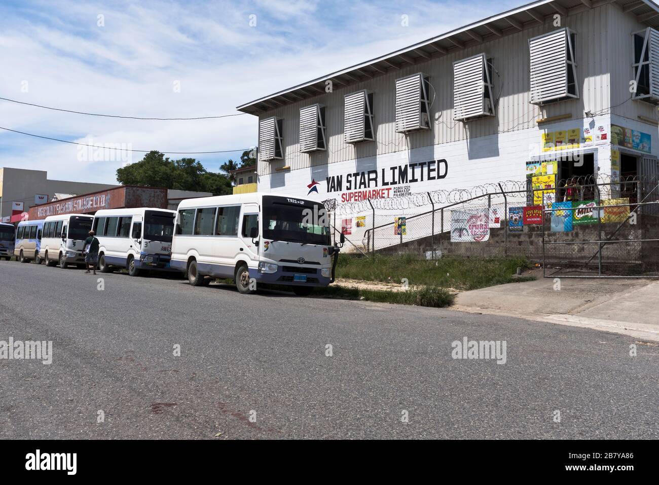 dh WEWAK PAPUA NEW GUINEA Row of local Mini bus vans Main street shop ...