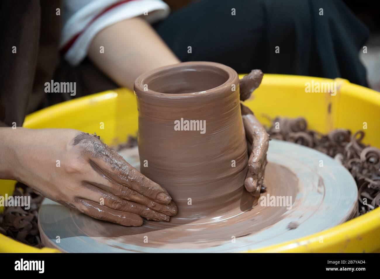 Selective focus shot of a person doing a traditional pottery making ...
