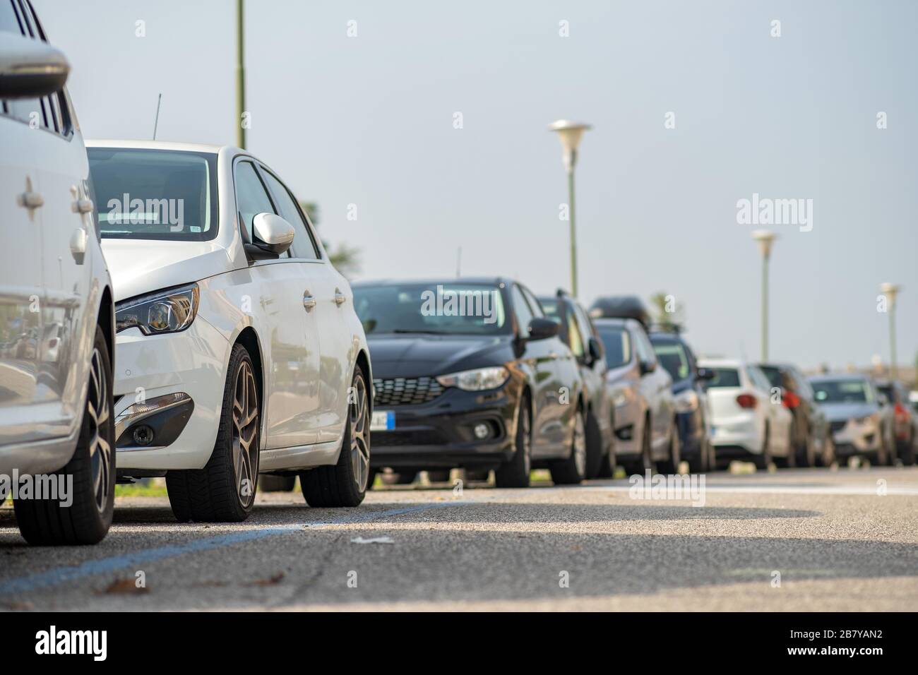 Modern cars parked on city street side in residential discrict. Shiny ...