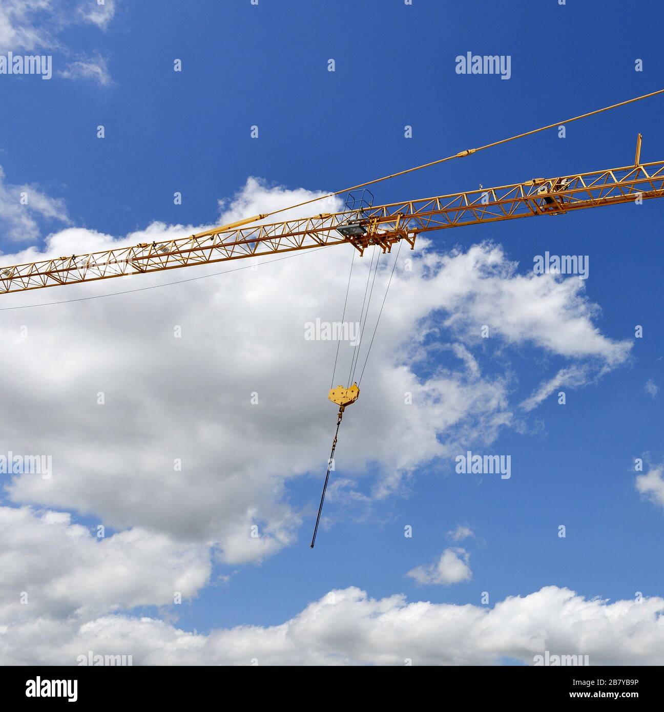 Tall tower crane showing hoist and chain Stock Photo - Alamy
