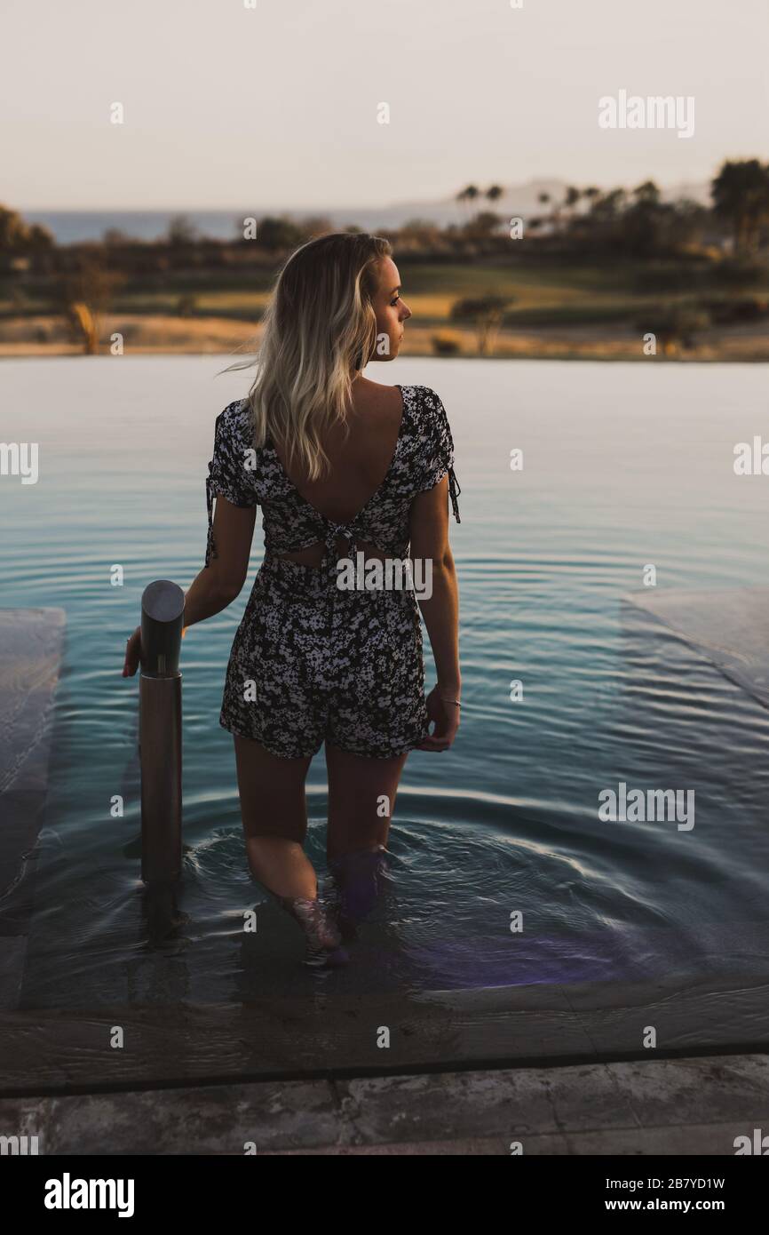 Young woman sunbathing in swimming pool hi-res stock photography and ...