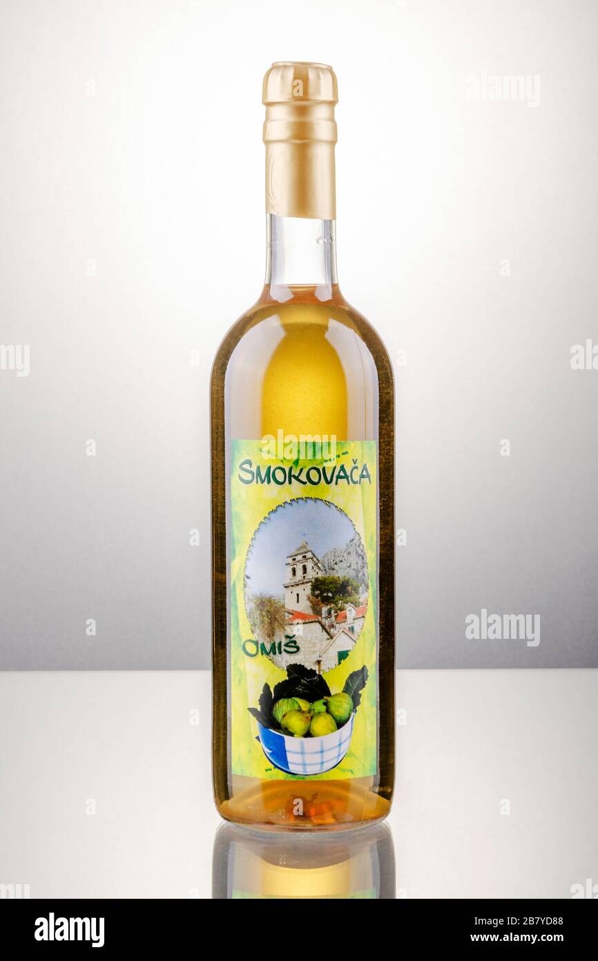 Bottle of fig flavored rakija isolated on gradient background produced ...