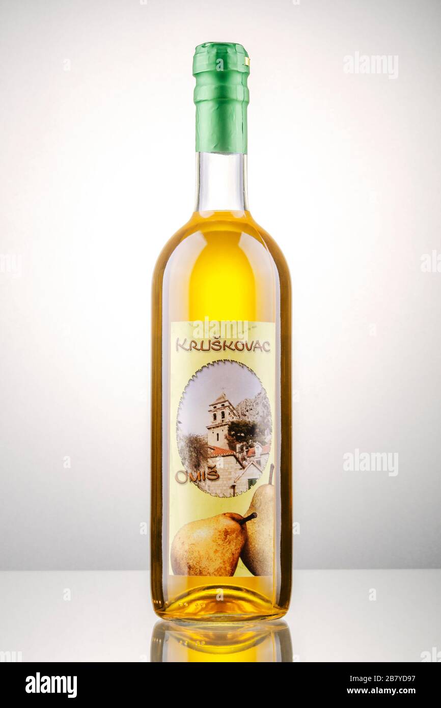 Bottle of pear flavored rakija isolated on gradient background produced ...