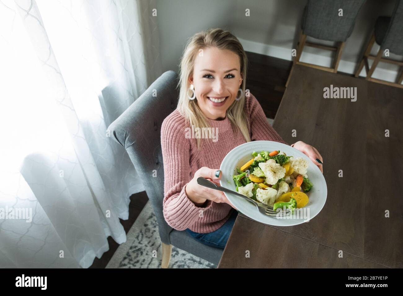 Young woman plate eating smiling hi-res stock photography and images ...