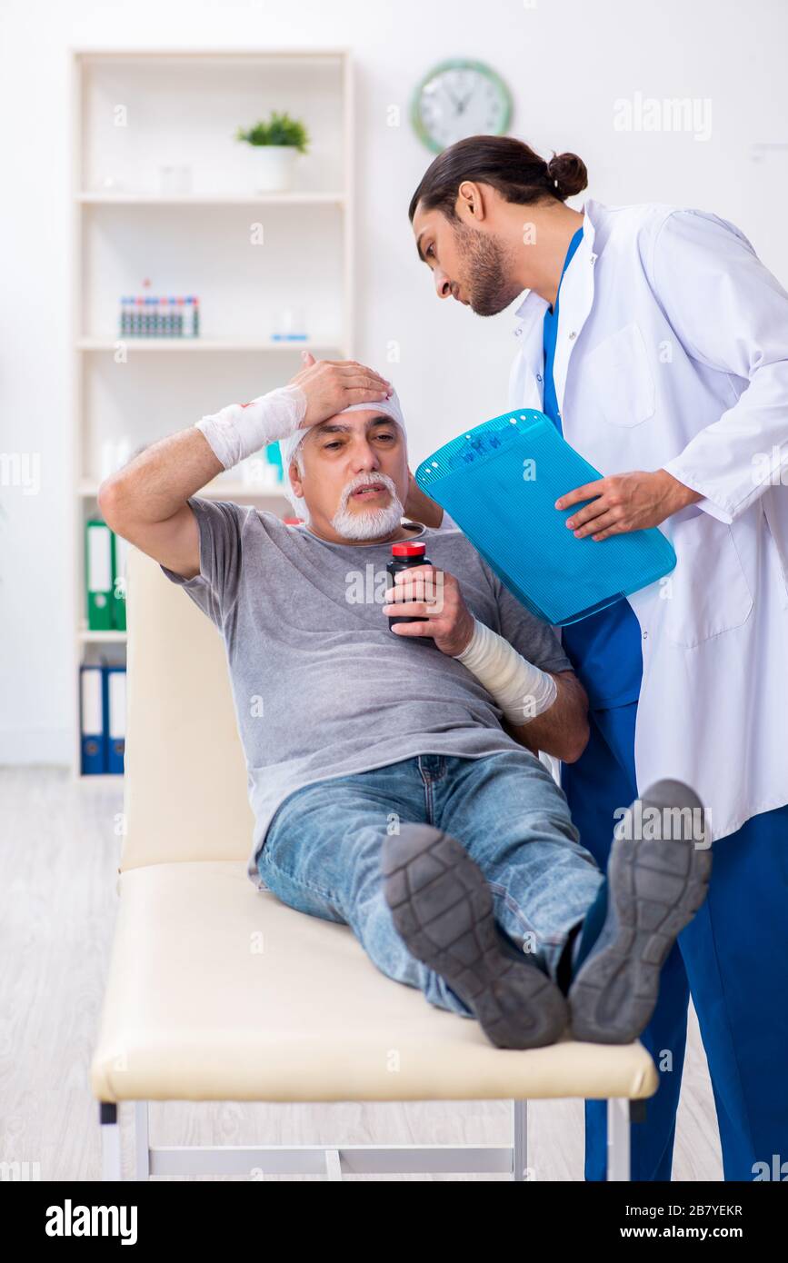 Young doctor taking notes elderly hi-res stock photography and images ...