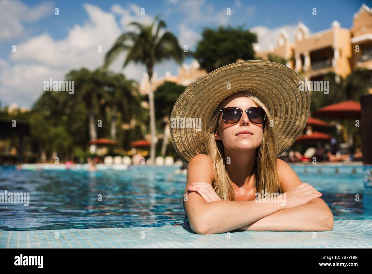 Woman sunbathing in pool hotel hi-res stock photography and images - Alamy