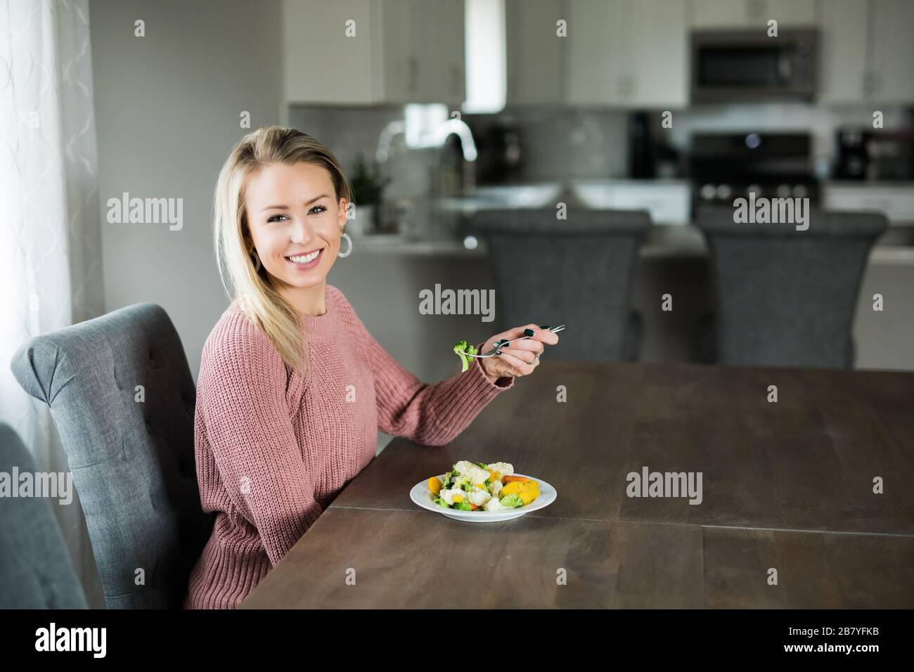 A young and attractive woman eating vegetables Stock Photo - Alamy