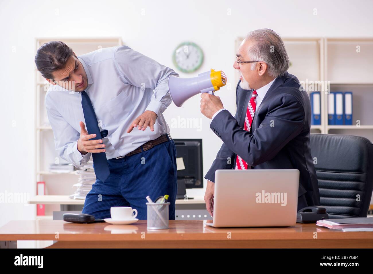 Old boss and young employee in the office Stock Photo - Alamy