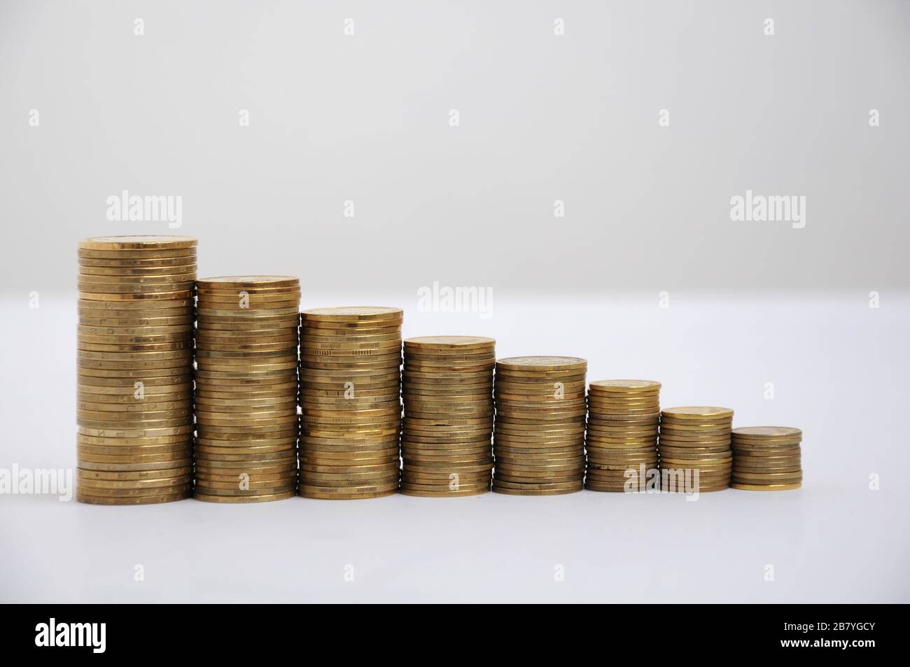 Columns of golden coins isolated on a white background Stock Photo - Alamy