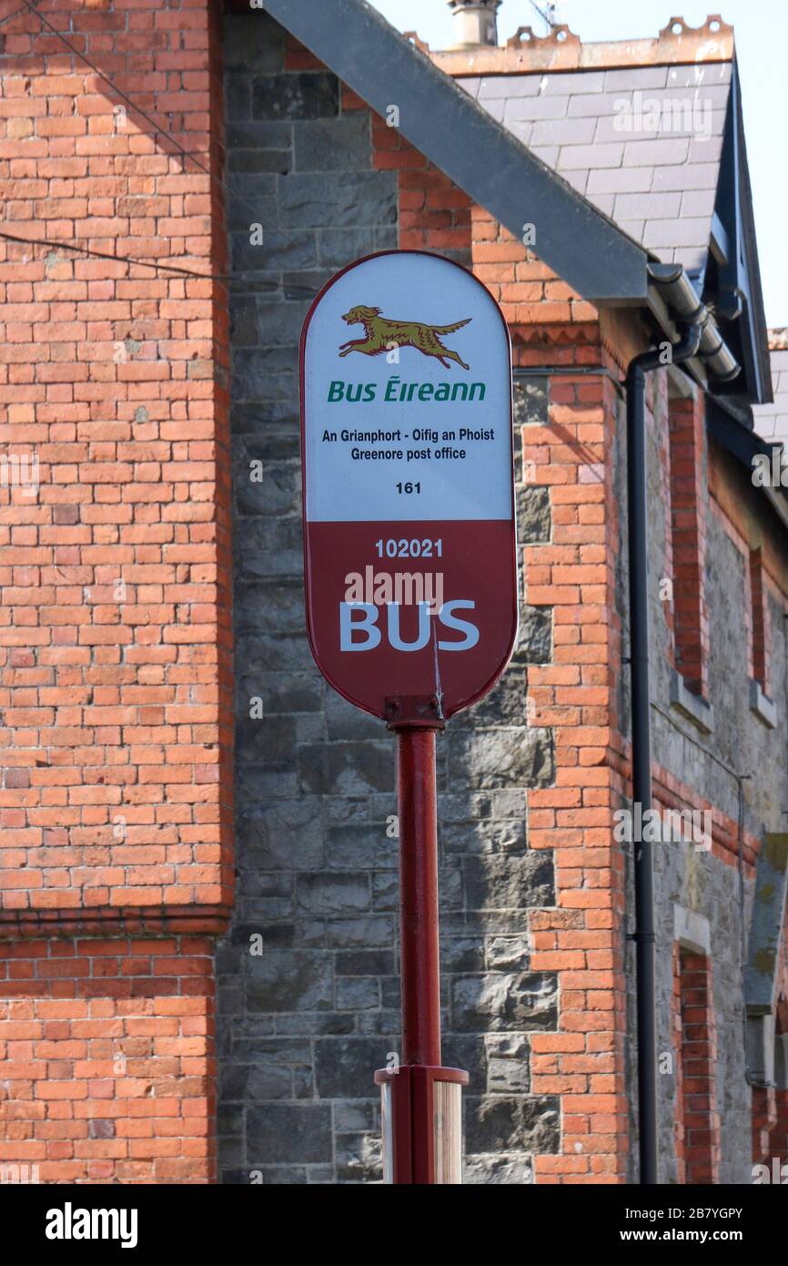 A bus stop sign in Ireland, the Bus Eireann stop sign with a red brick ...