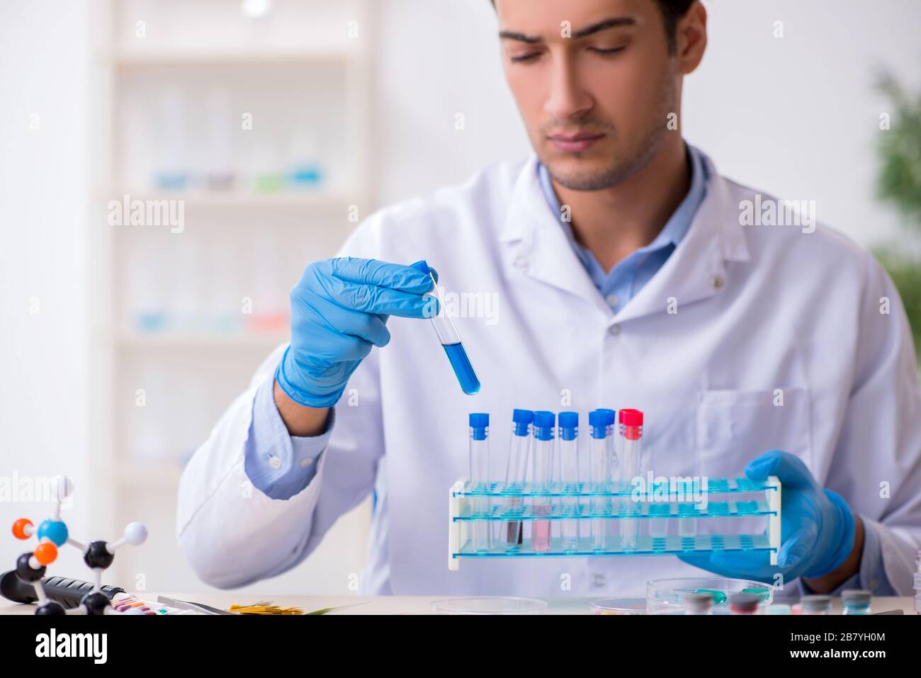 Young male lab assistant in the drug synthesis concept Stock Photo - Alamy