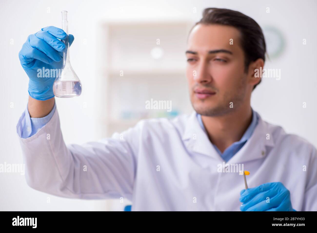 Young male lab assistant in the drug synthesis concept Stock Photo - Alamy