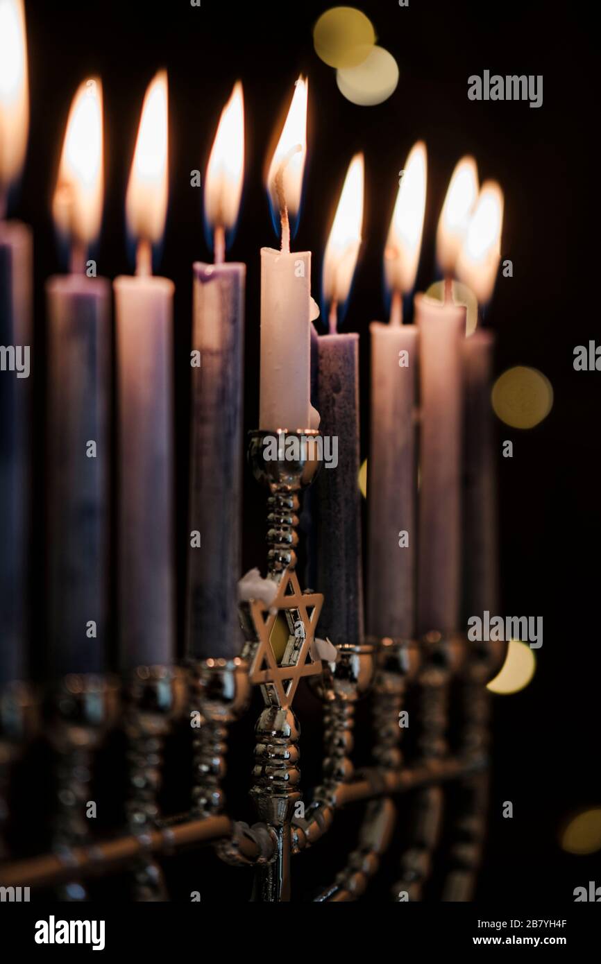 Lit candles in menorah Stock Photo - Alamy