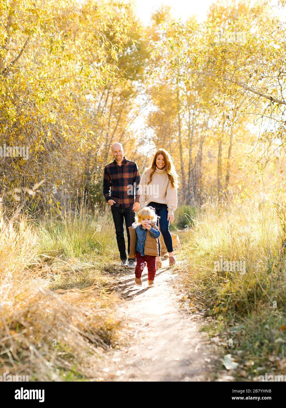 Family three walking on path hi-res stock photography and images - Alamy