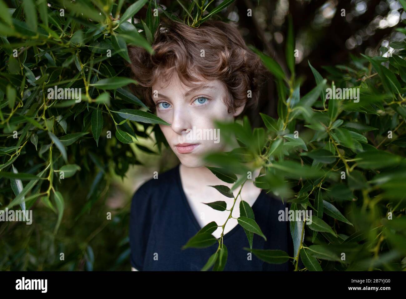 Woman behind branches leaf hi-res stock photography and images - Alamy