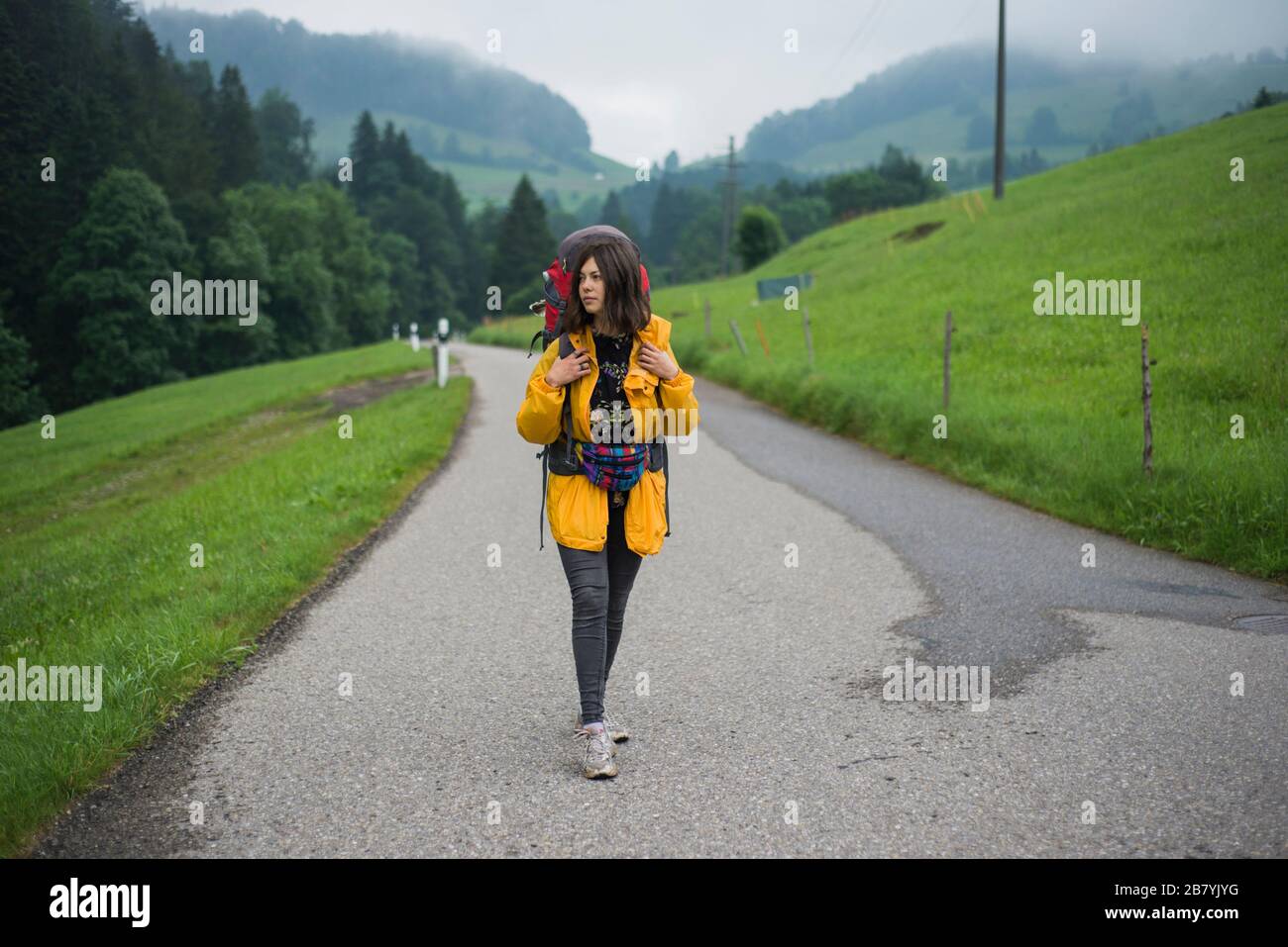 Woman walking away country road hi-res stock photography and images - Alamy