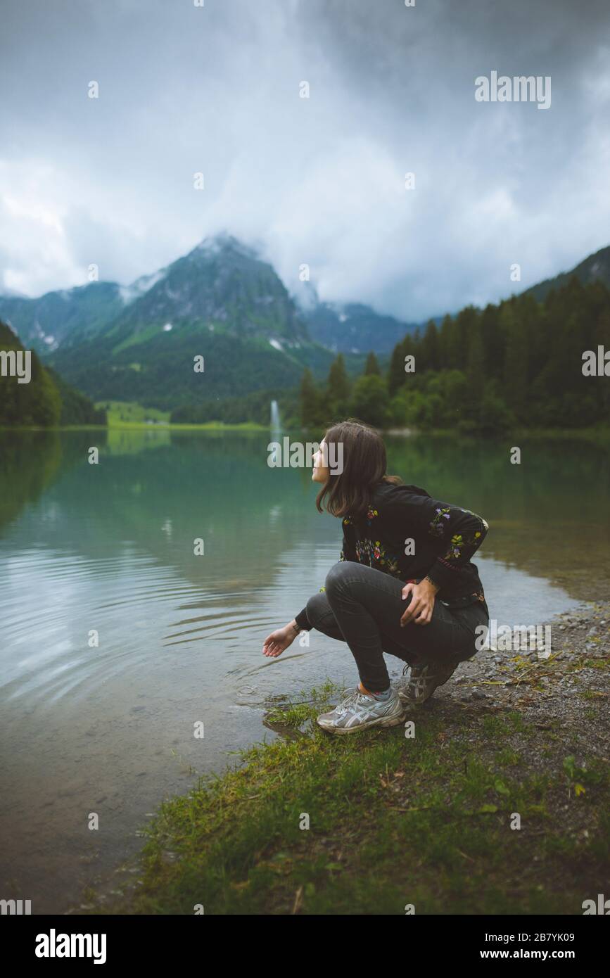 Young woman crouching side view hi-res stock photography and images - Alamy