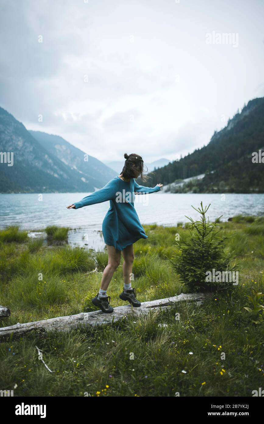 Woman balancing on log by lake hi-res stock photography and images - Alamy
