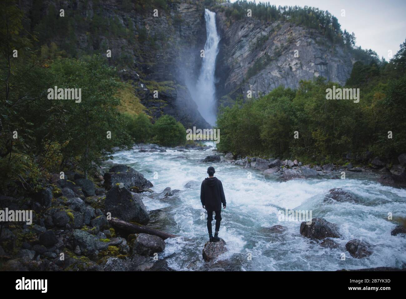 Man standing waterfall cliff activity hi-res stock photography and ...