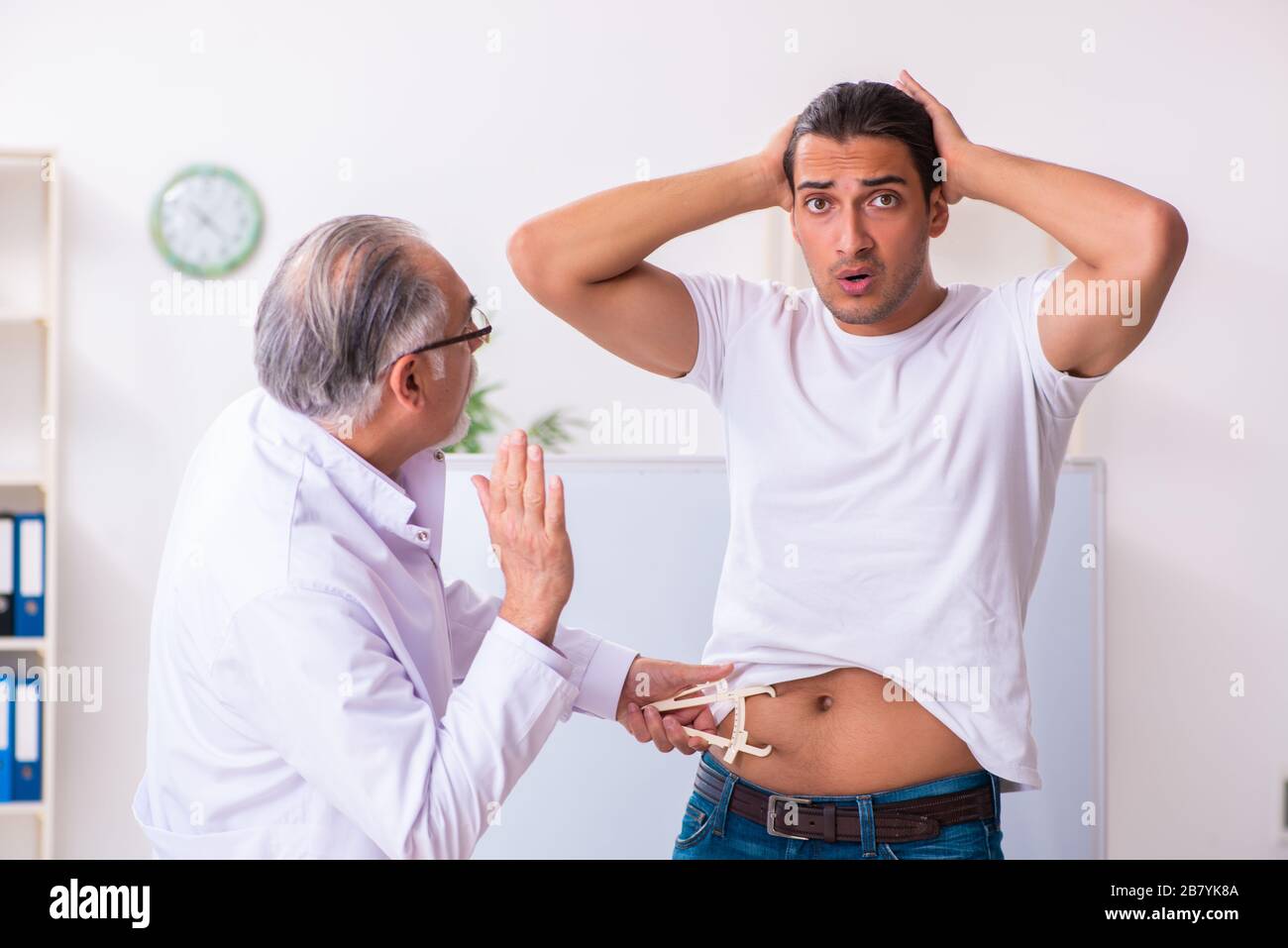 The doctor dietician giving advices to fat overweight patient Stock ...