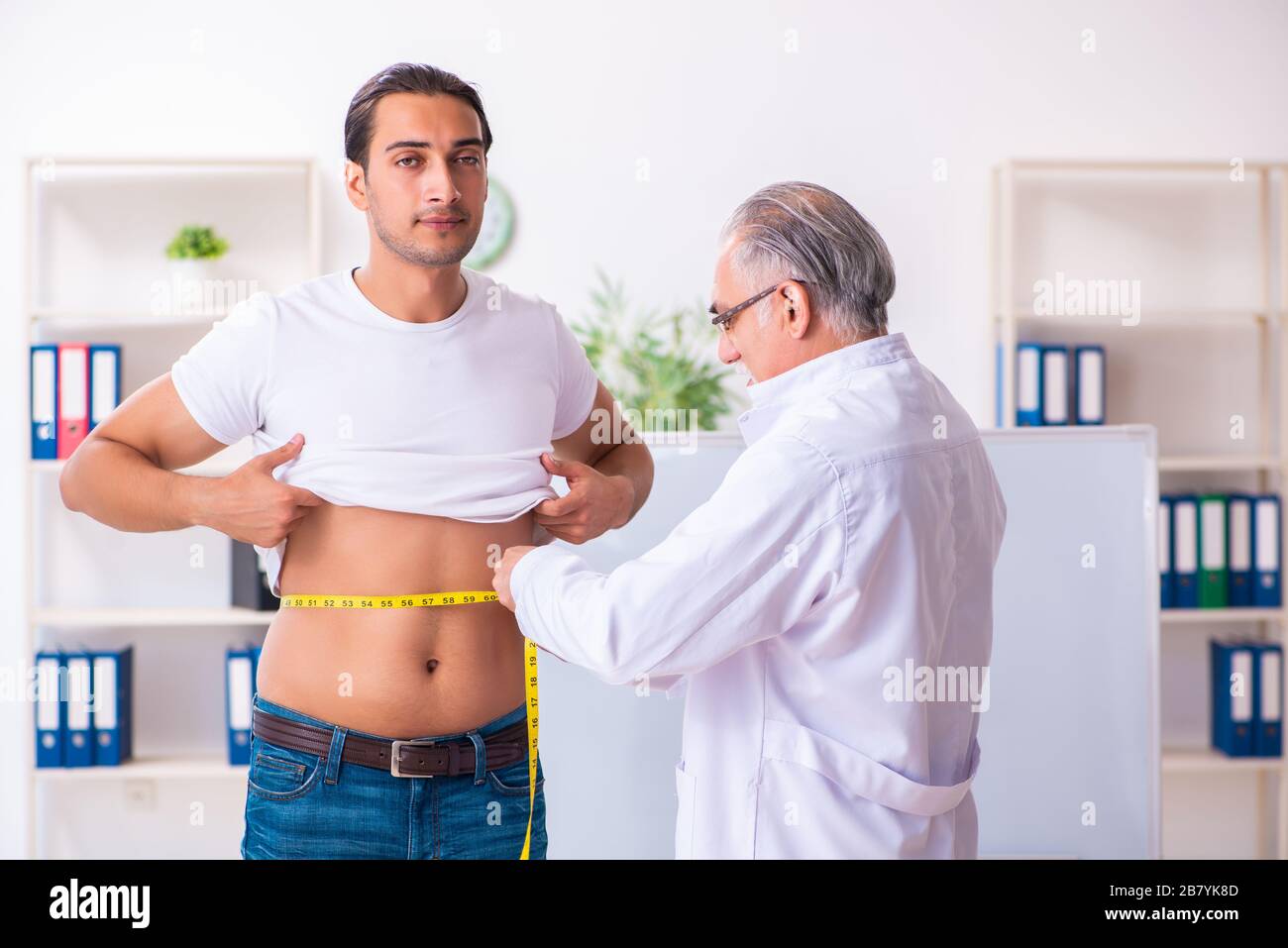 The doctor dietician giving advices to fat overweight patient Stock ...