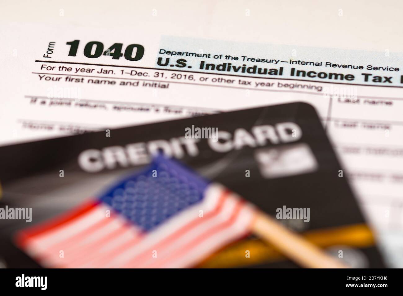 Tax Return form 1040 with credit card and USA flag : U.S. Individual ...
